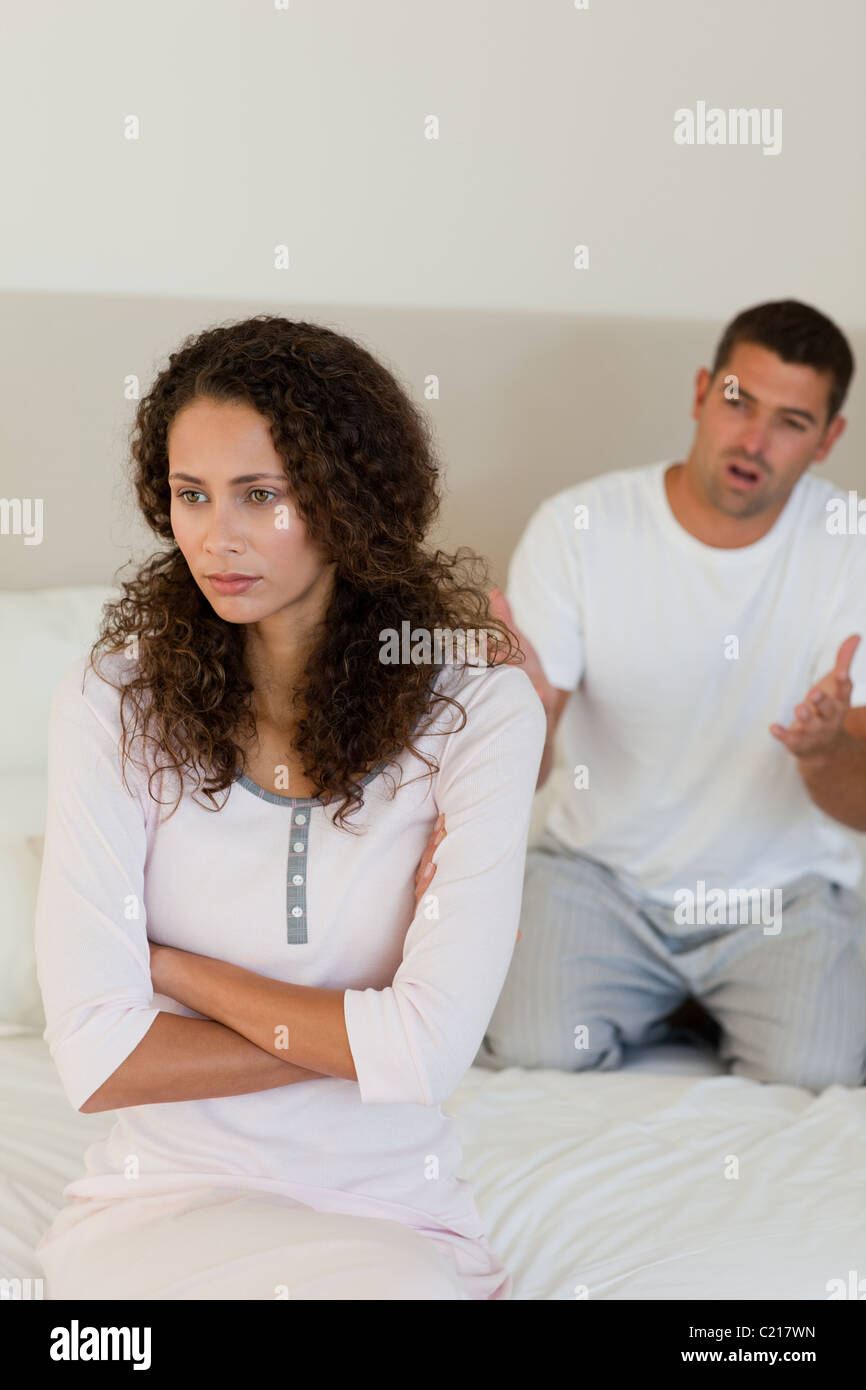 Young couple having a dispute on the bed Stock Photo - Alamy