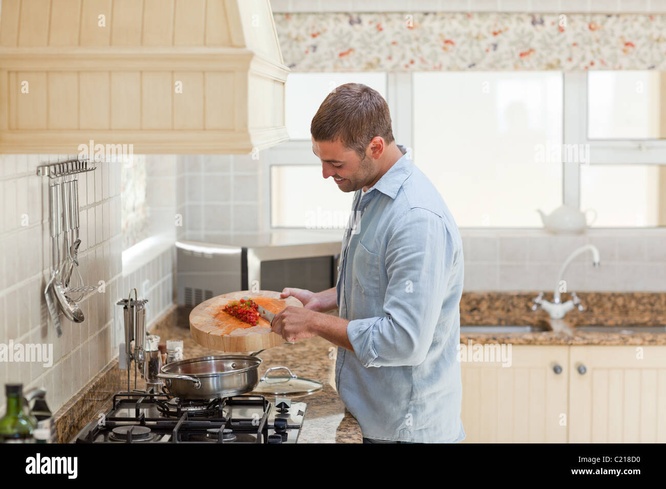 Handsome man cooking in the kitchen Stock Photo - Alamy