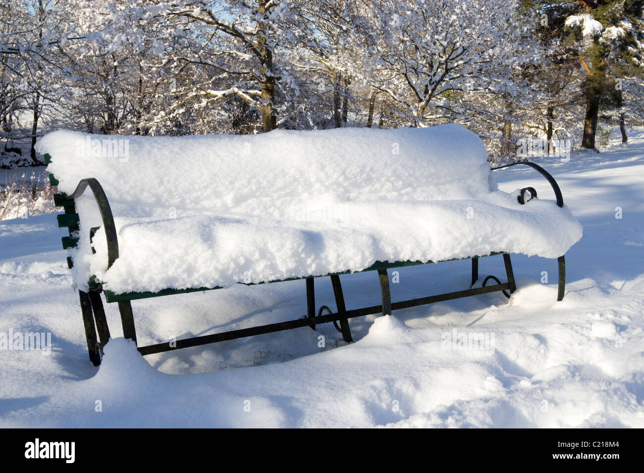 A park bench seat covered in lots of snow Stock Photo - Alamy