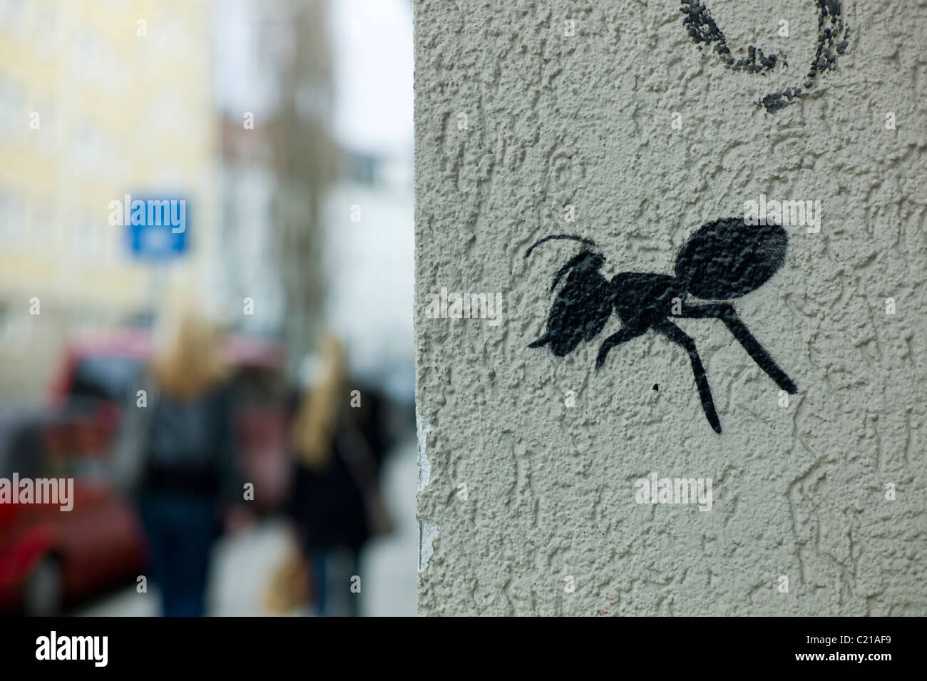 Graffiti showing a black ant on the corner of a white wall in Munich ...