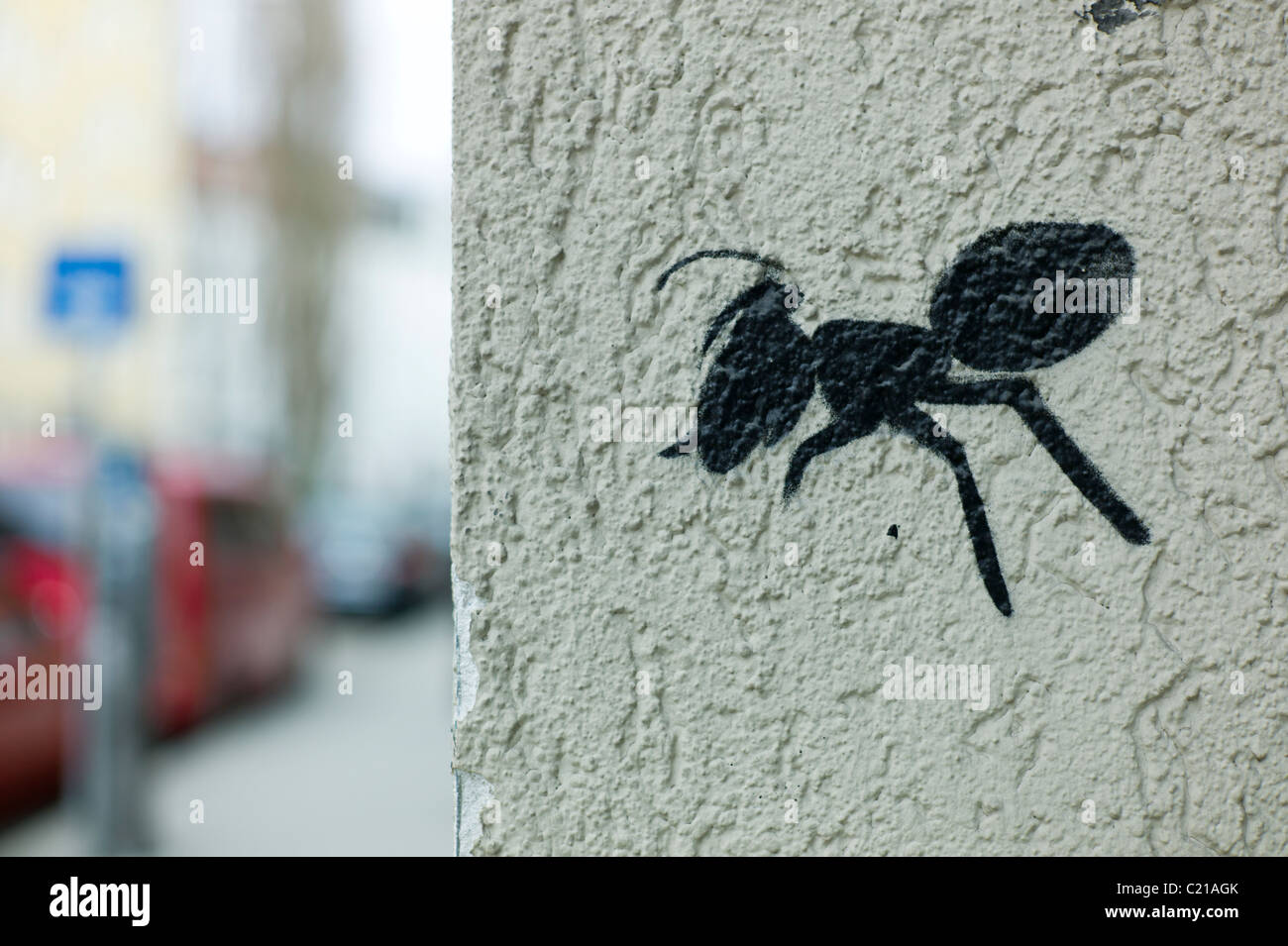 Graffiti showing a black ant on the corner of a white wall in Munich ...