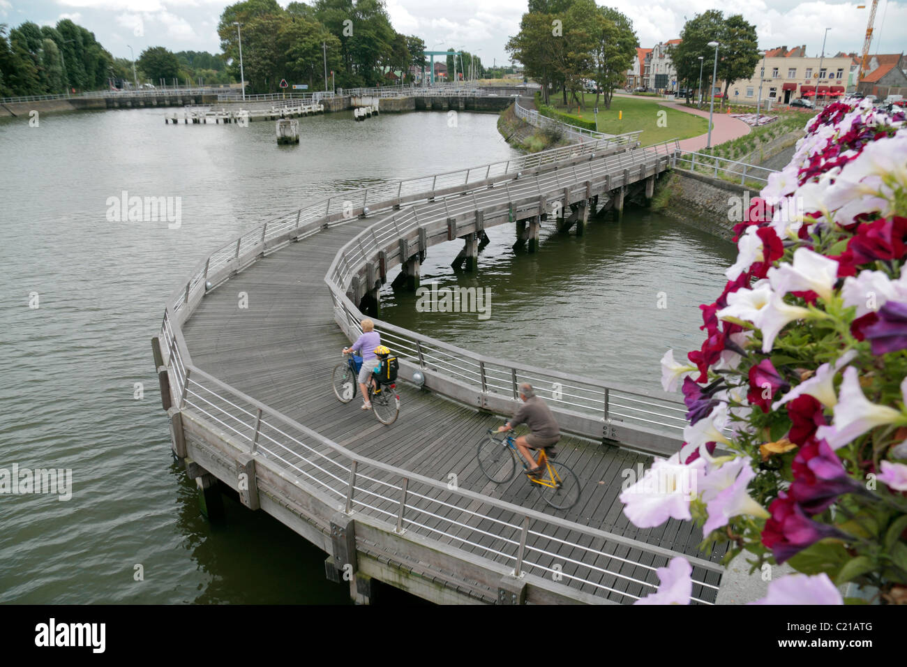 Cyclists on cycle path elevated over the river in Nieuwpoort, West ...