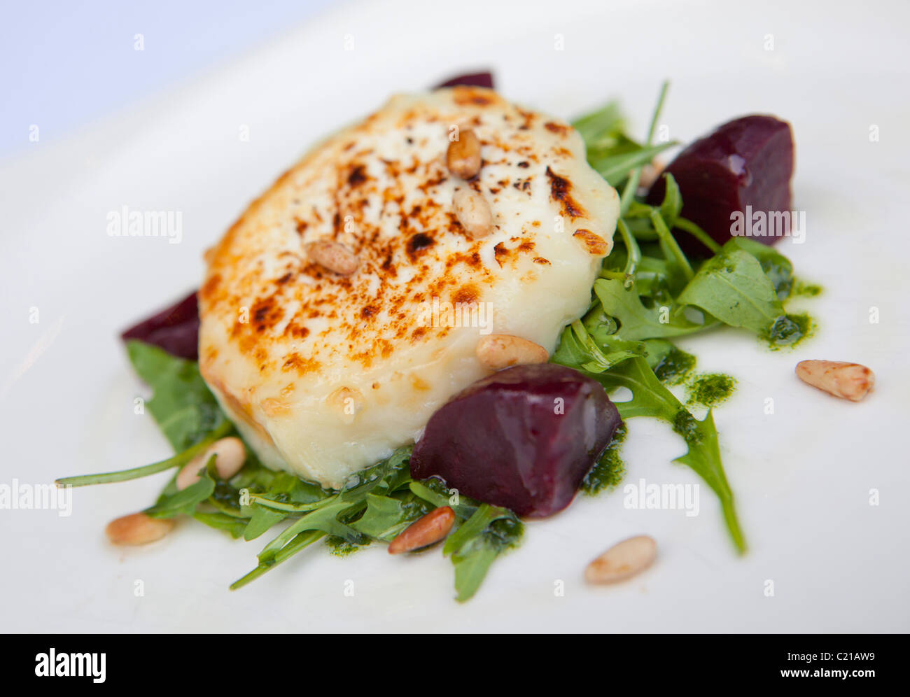 Starter of goats cheese on a bed of rocket with beetroot, pine nuts and ...