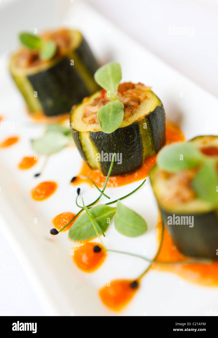 Starter of stuffed courgettes served with a butternut squash sauce ...