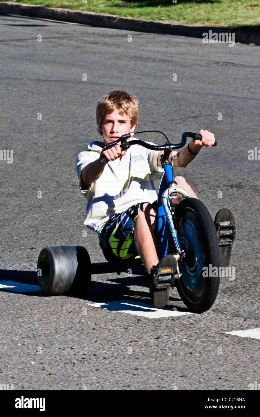 A boy on a tricycle, playing on the road Stock Photo - Alamy