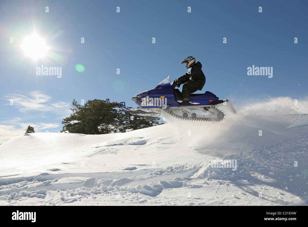 man and fast action snowmobile jumping Stock Photo - Alamy