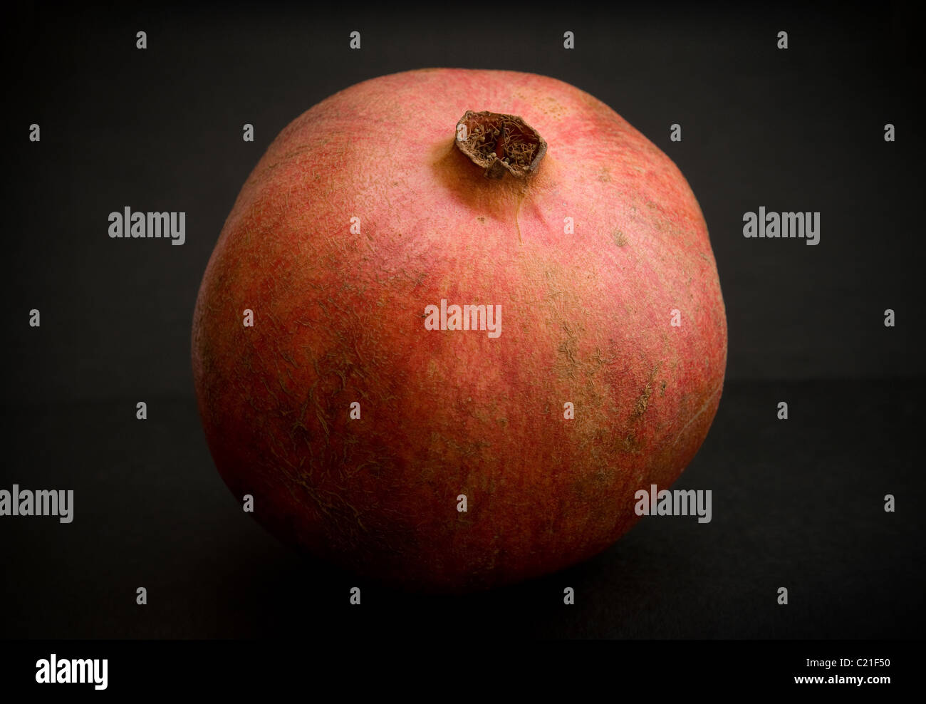 Perfect fresh pomegranate at dark background Stock Photo - Alamy