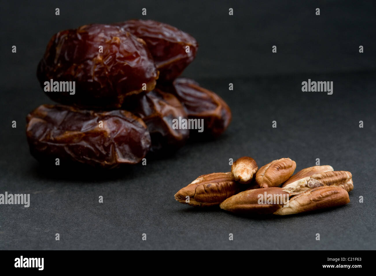 Batch of dried dates and date seeds Stock Photo - Alamy