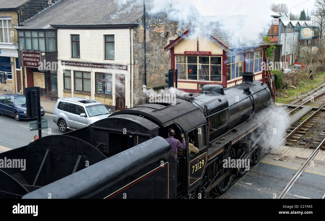 Standard Class 5 steam locomotive crosses the level crossing outside ...