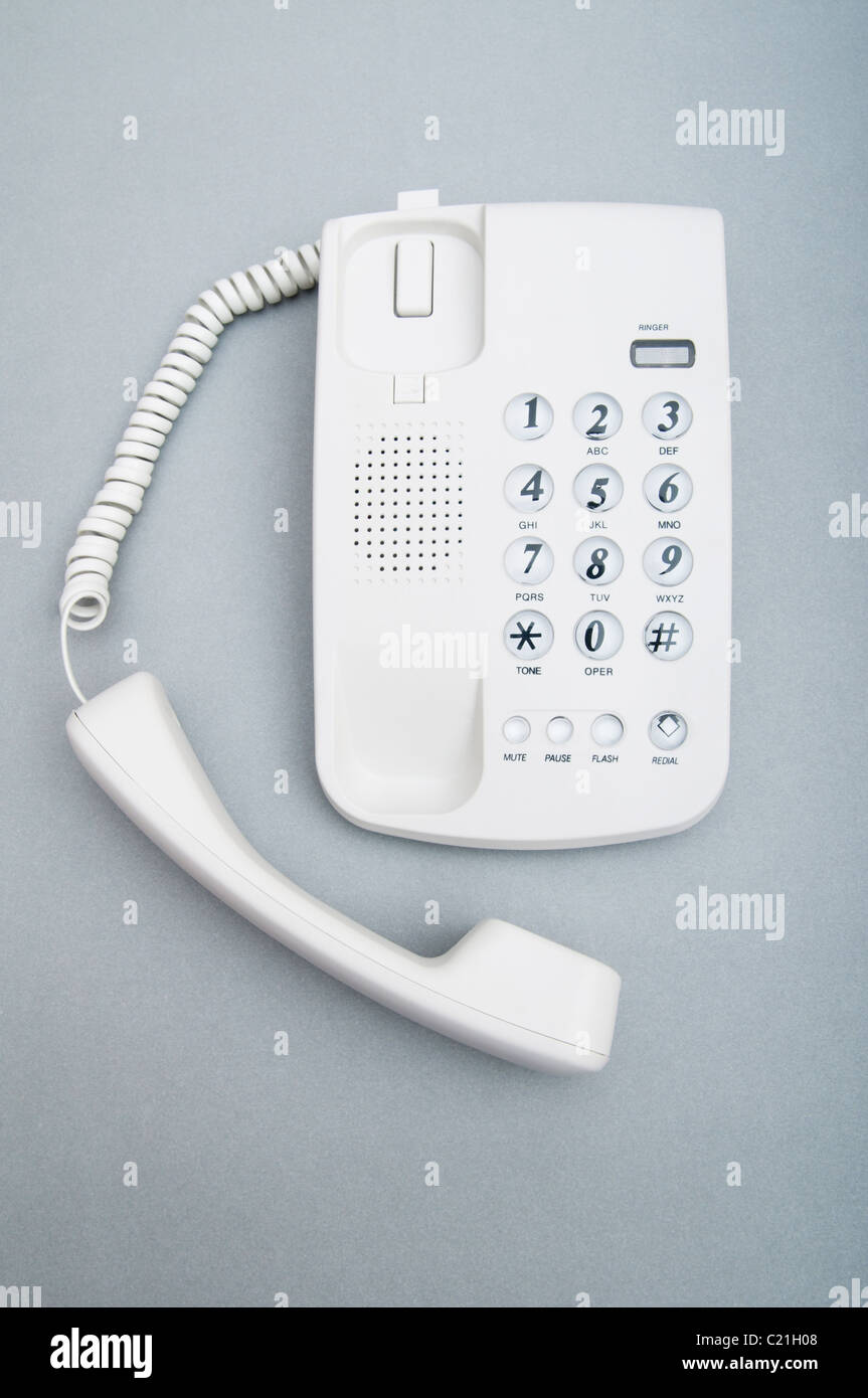 White office phone on the flat surface Stock Photo - Alamy