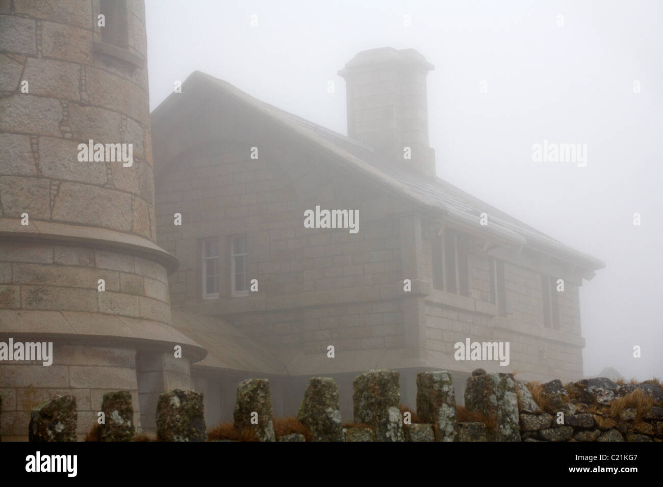 Old light house cottage, next to the old lighthouse surrounded by thick ...