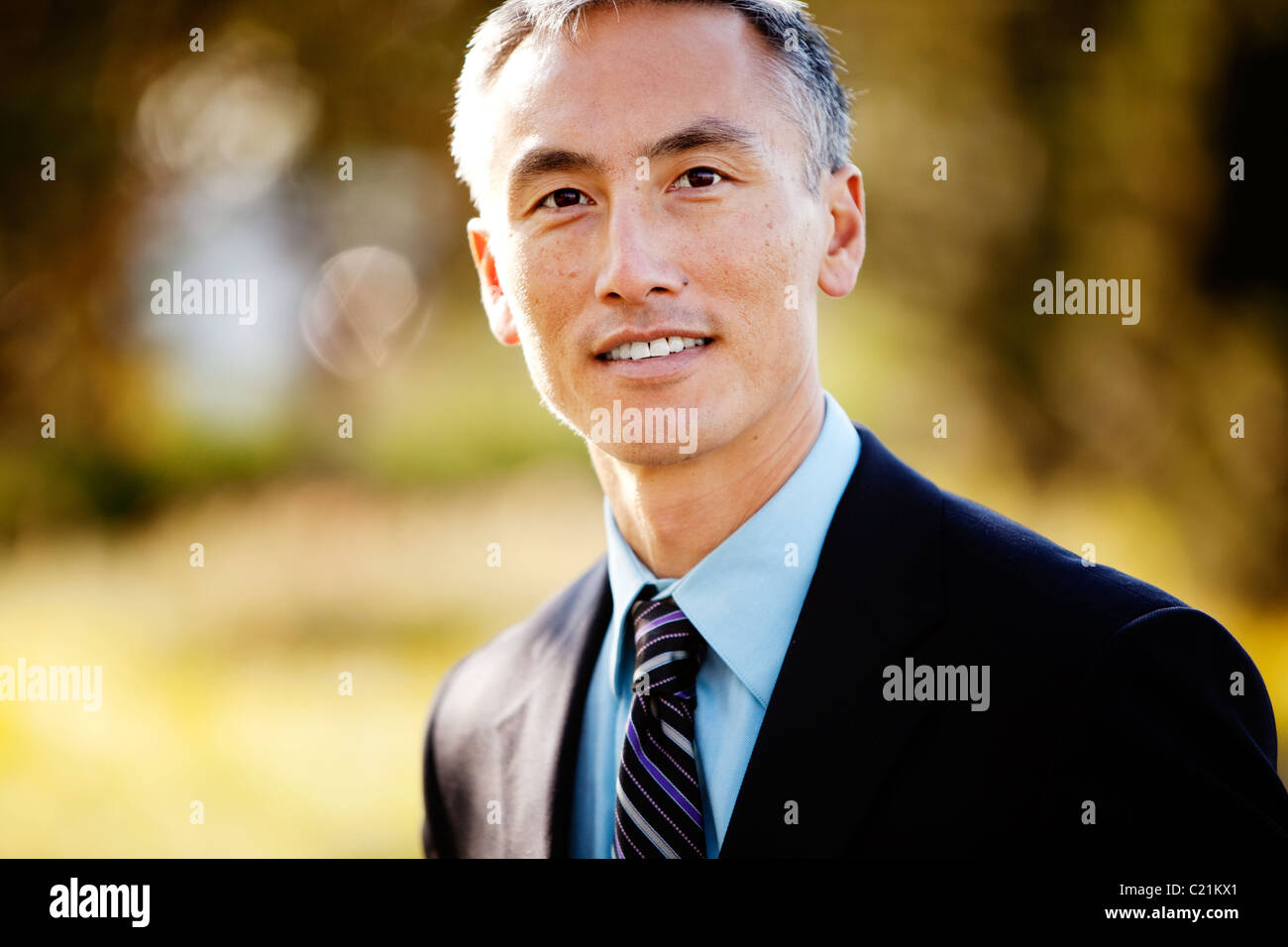A portrait of a friendly Asian looking business man Stock Photo - Alamy