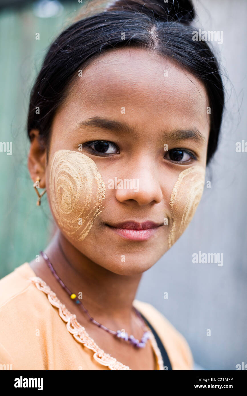Portrait of a Burmese girl with cheeks painted with thanaka face paint ...