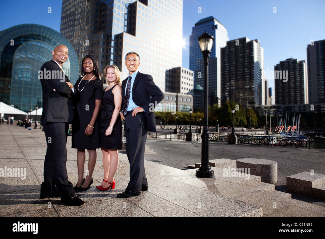 A successful business team in an outdoor setting against a city ...