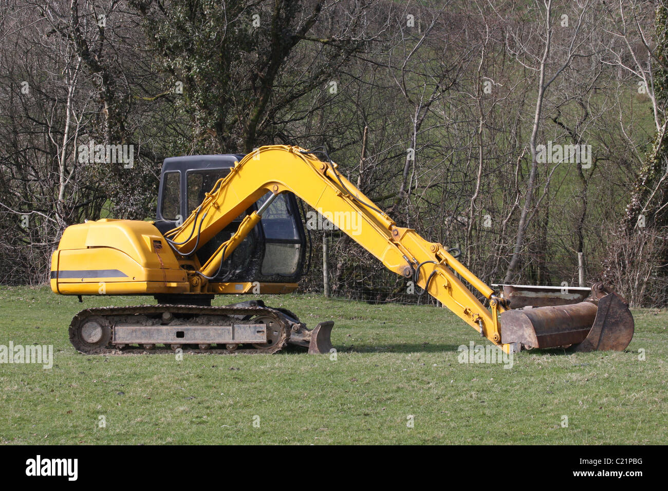 Digger excavator at work in a field Stock Photo - Alamy