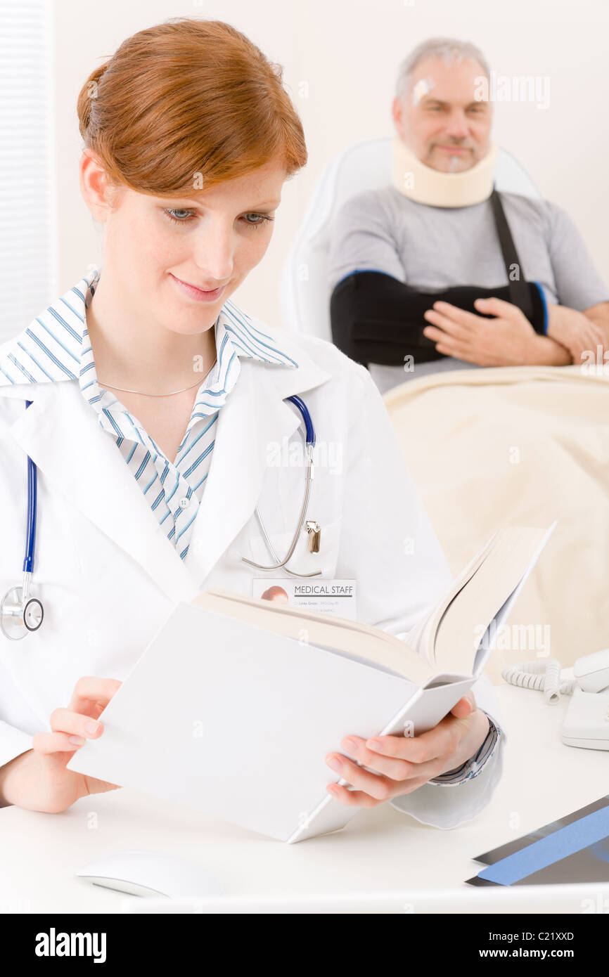 Doctor office - portrait female physician read book senior patient ...