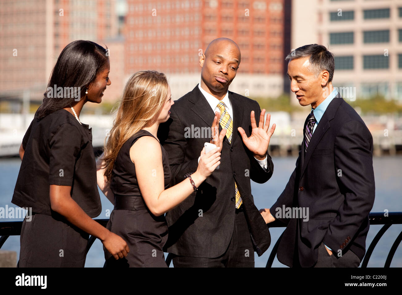 A group of business people outdoors in a discussion Stock Photo - Alamy