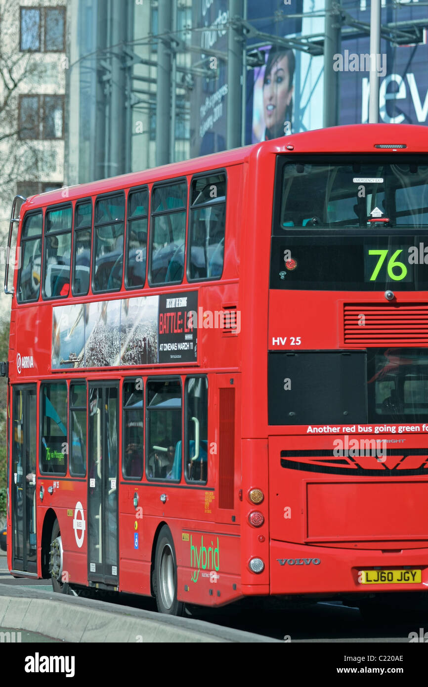 A double decker red London bus traveling on its route through ...