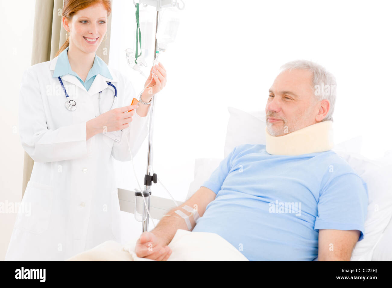 Hospital - female doctor with IV drip to senior patient Stock Photo - Alamy