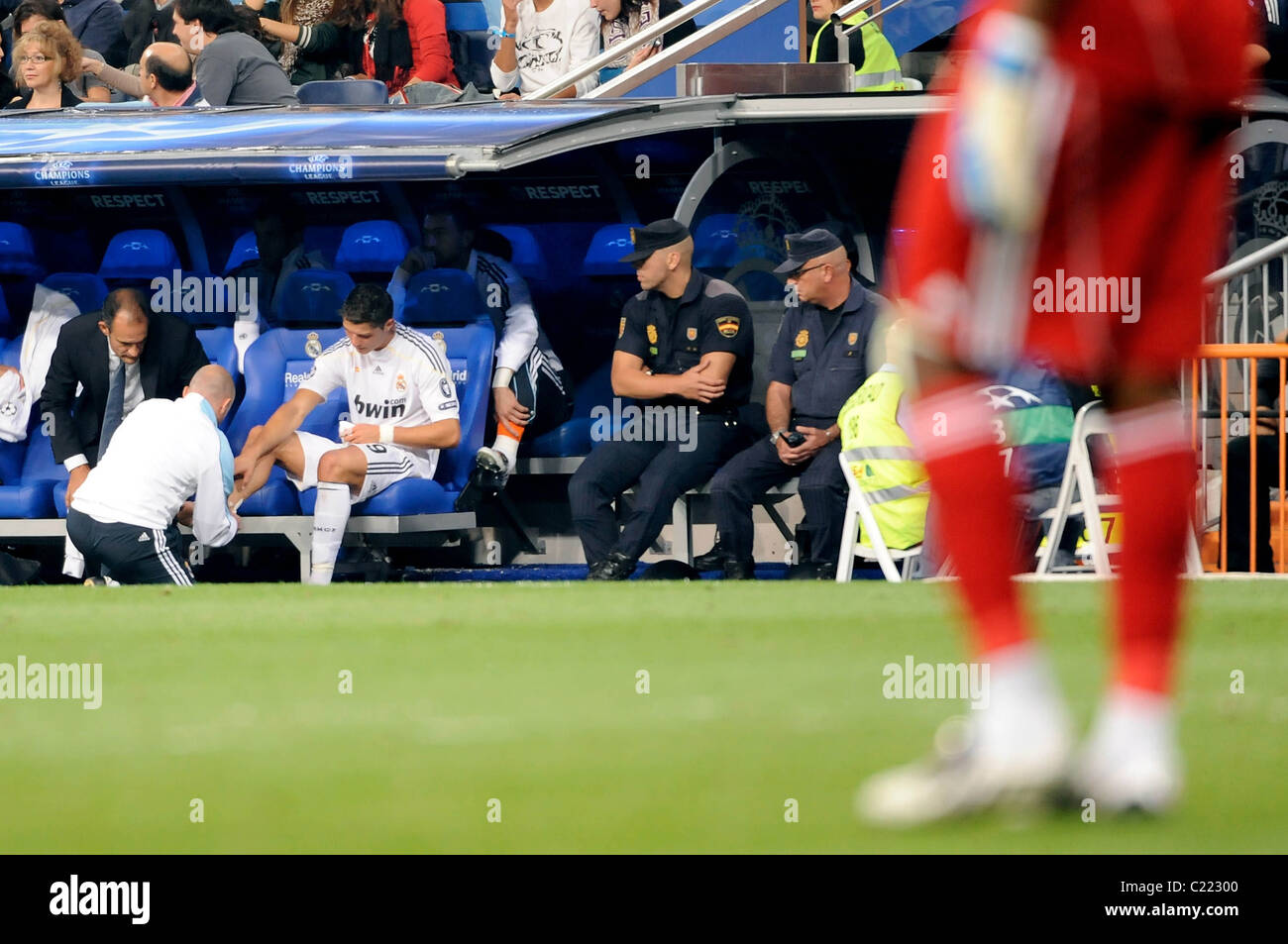 Cristiano Ronaldo receives treatment on the bench during the match ...