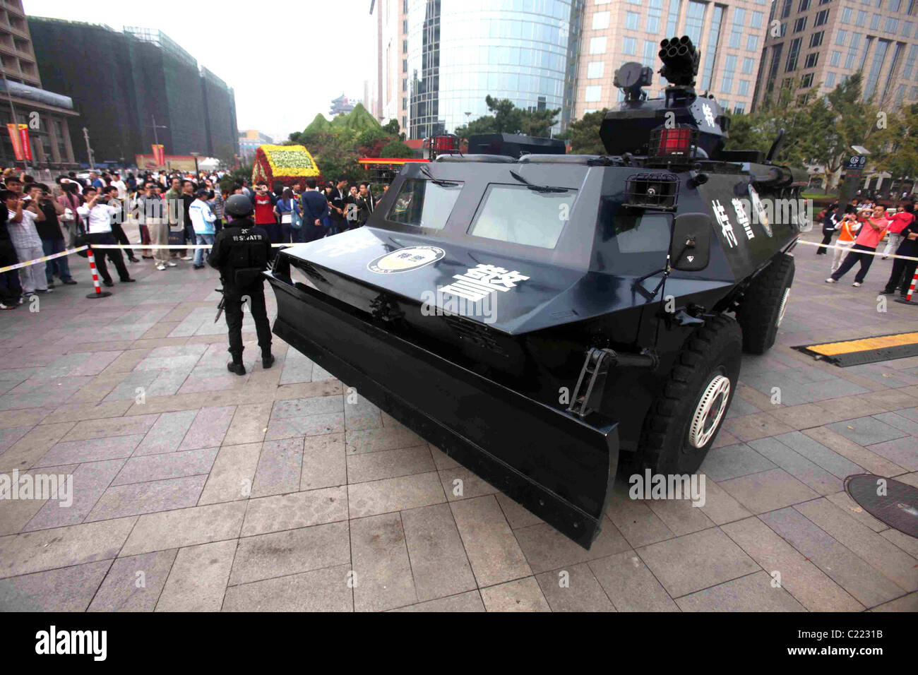 Tourists pose for pictures with an armoured police unit, during a ...