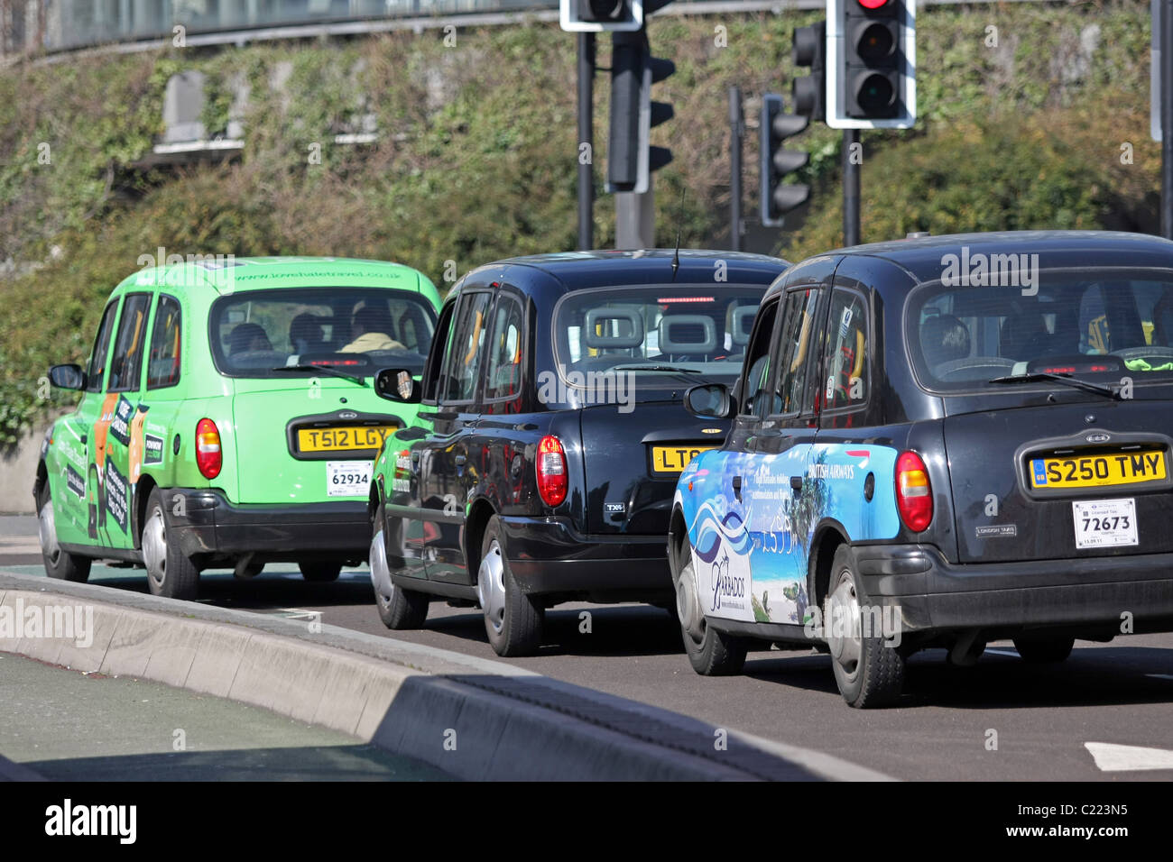 Three London Taxis in a queue at traffic lights in London Stock Photo ...