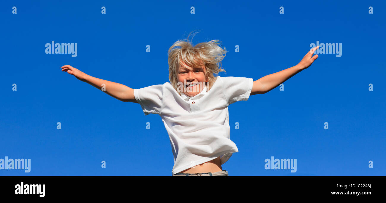 Cute Kid Jumping in the air outdoor Stock Photo - Alamy