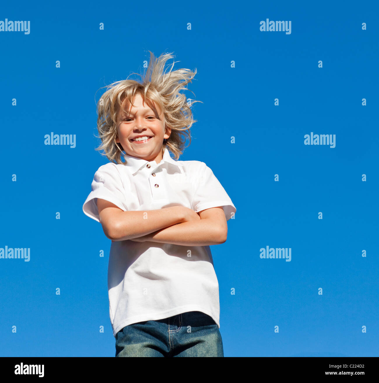 Cute Kid with arms folded having fun outdoor Stock Photo - Alamy