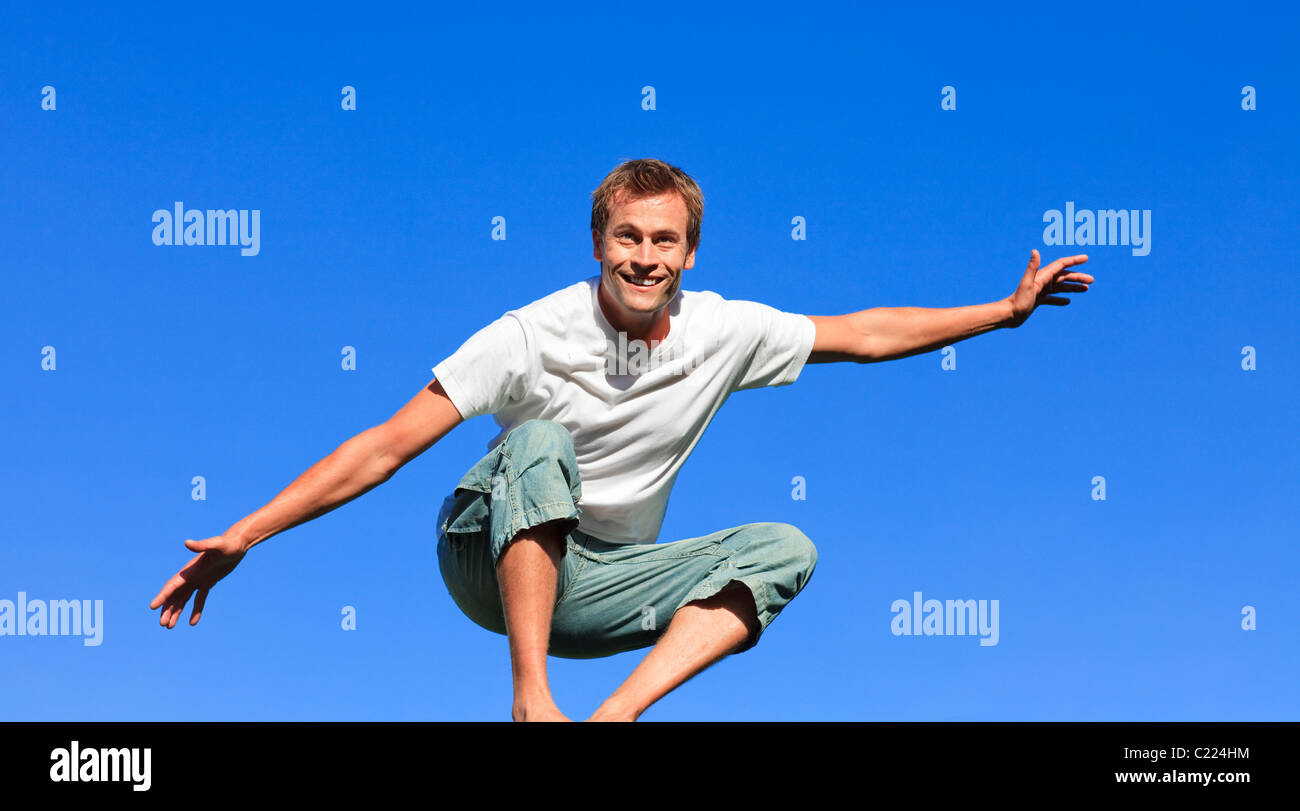 Handsome Man jumping in the air outdoor Stock Photo - Alamy