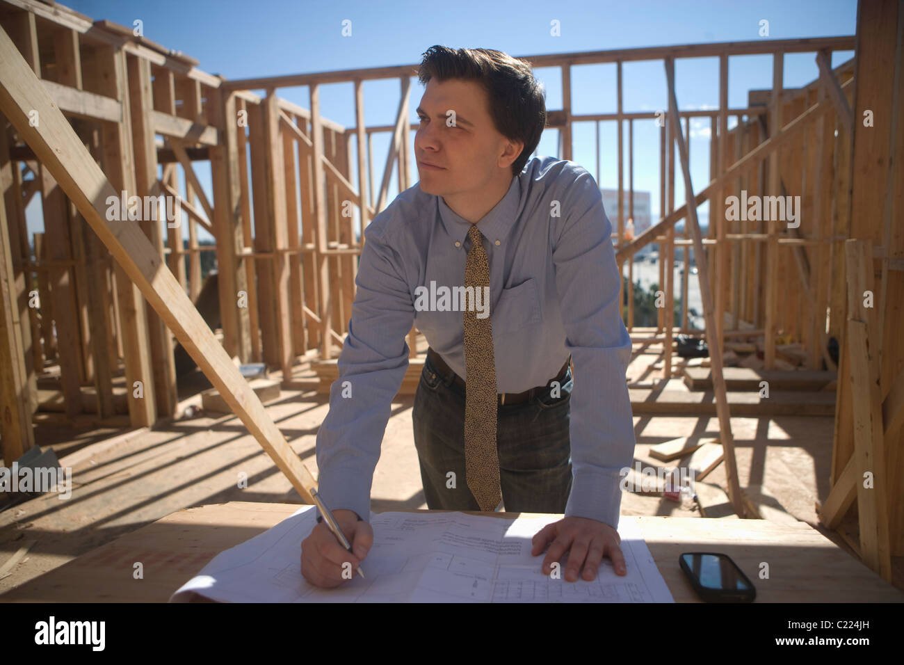 Site manager with building plans Stock Photo - Alamy