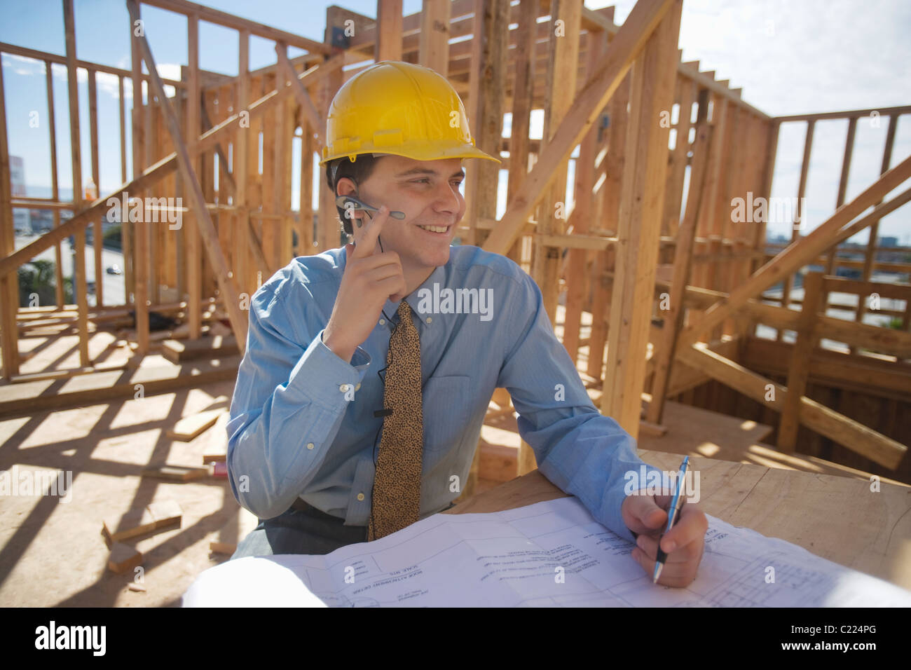 Site manager with building plans Stock Photo - Alamy