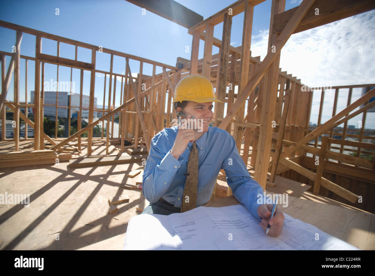 Site manager with building plans Stock Photo - Alamy