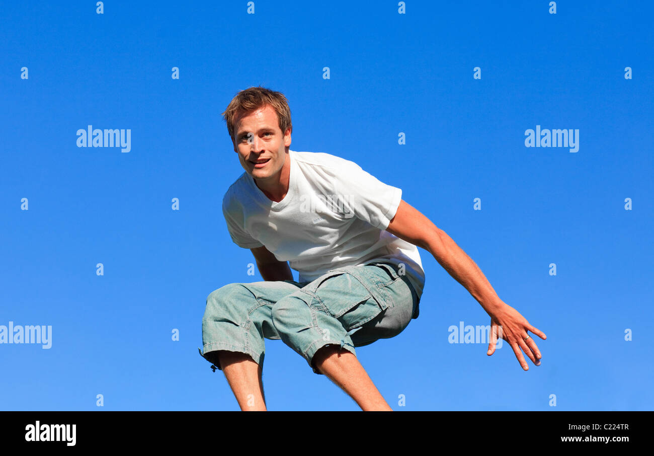Portrait of a happy Man jumping in the air outdoor Stock Photo - Alamy