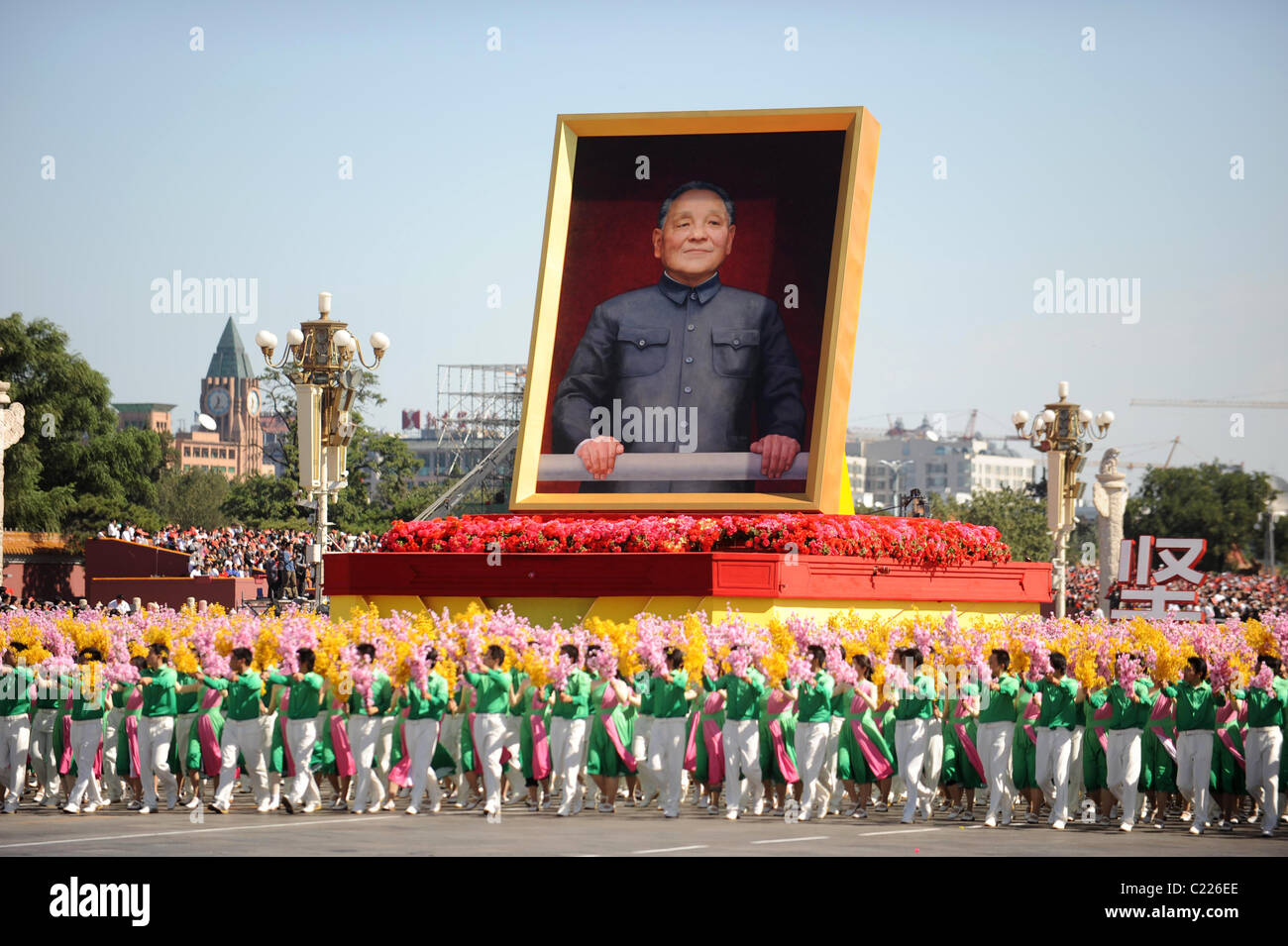 A large portrait of Chinese Communist leader, Deng Xiaoping drives past ...