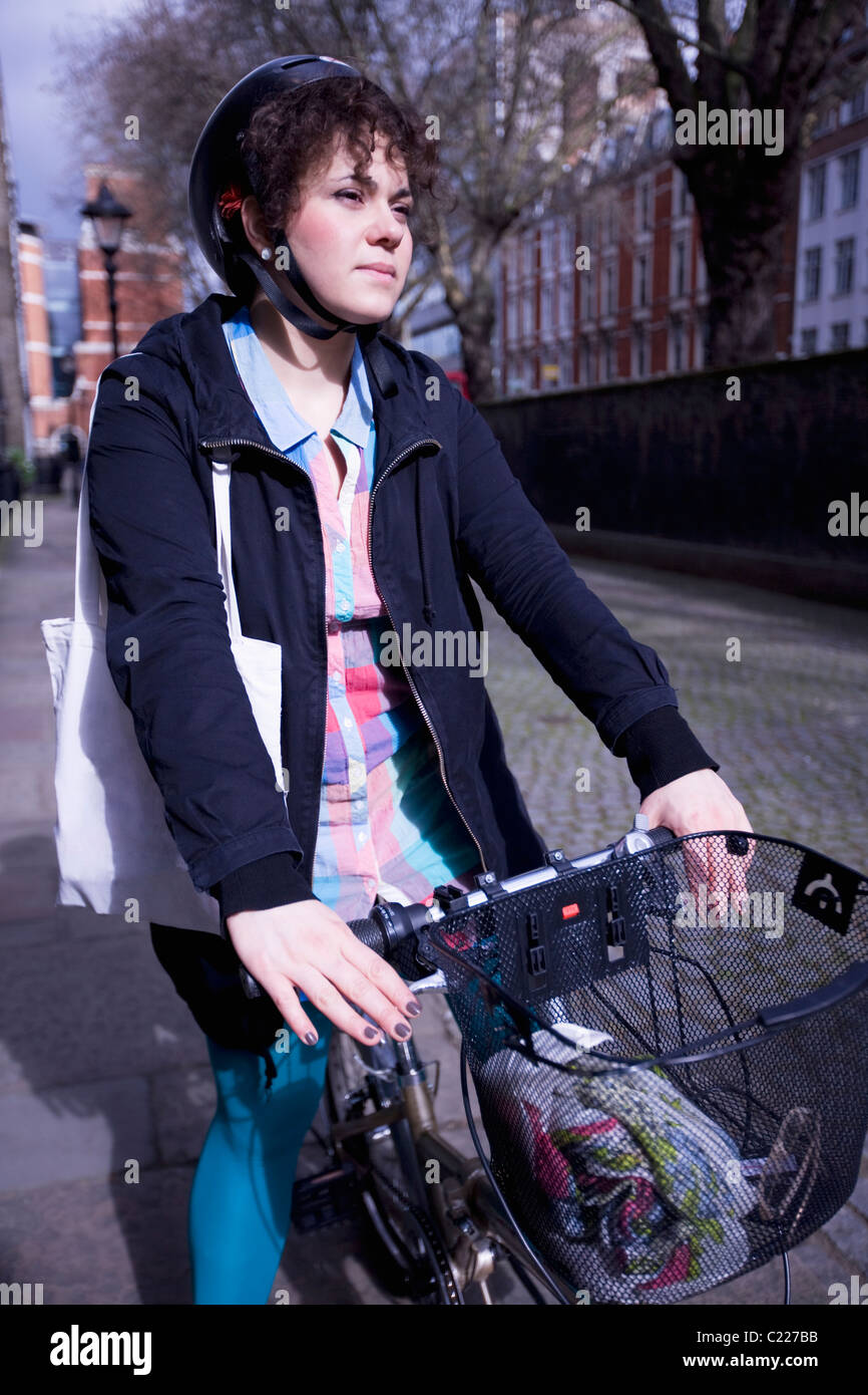 A female adult riding her bicycle Stock Photo - Alamy