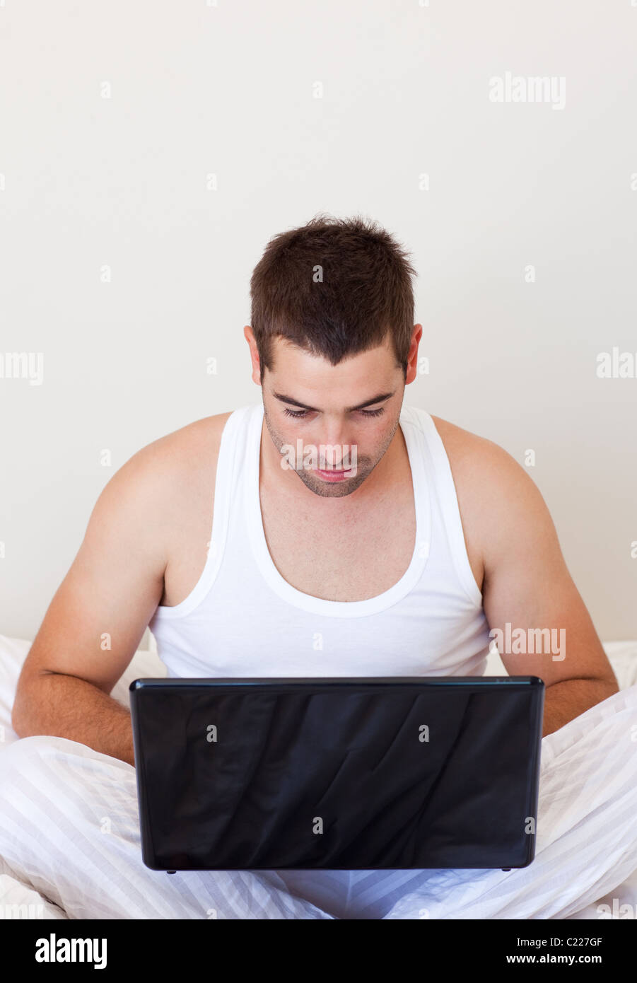 Attractive man using a laptop Stock Photo - Alamy