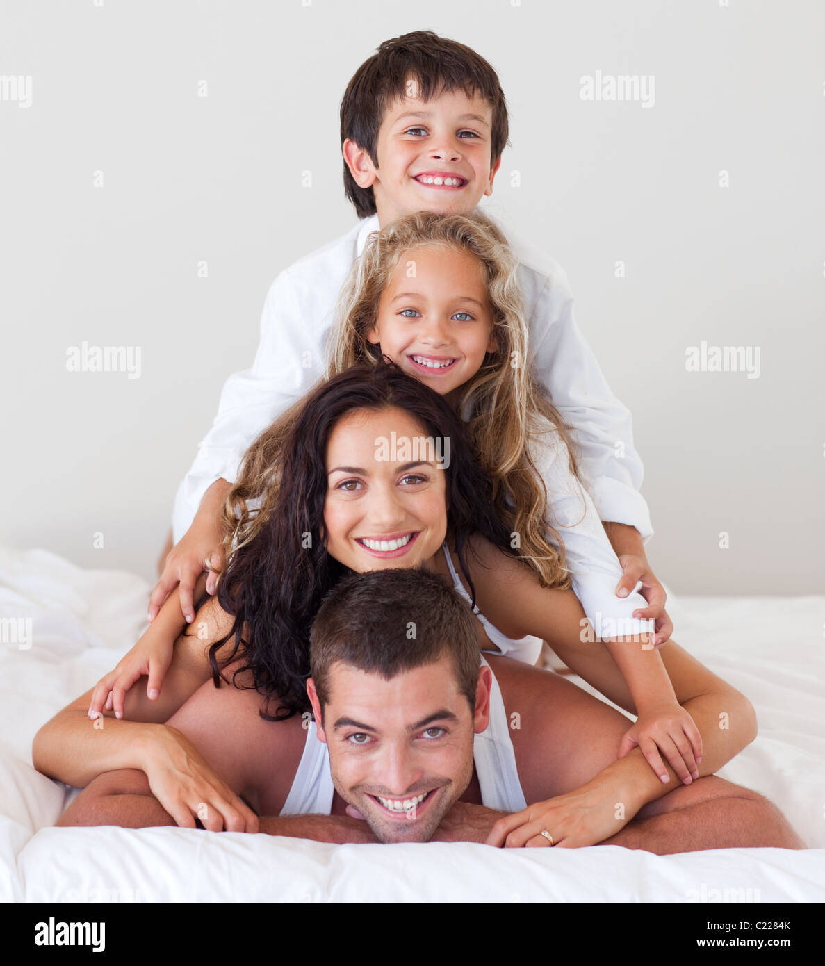 Cute girl and boy having fun with their parents Stock Photo - Alamy