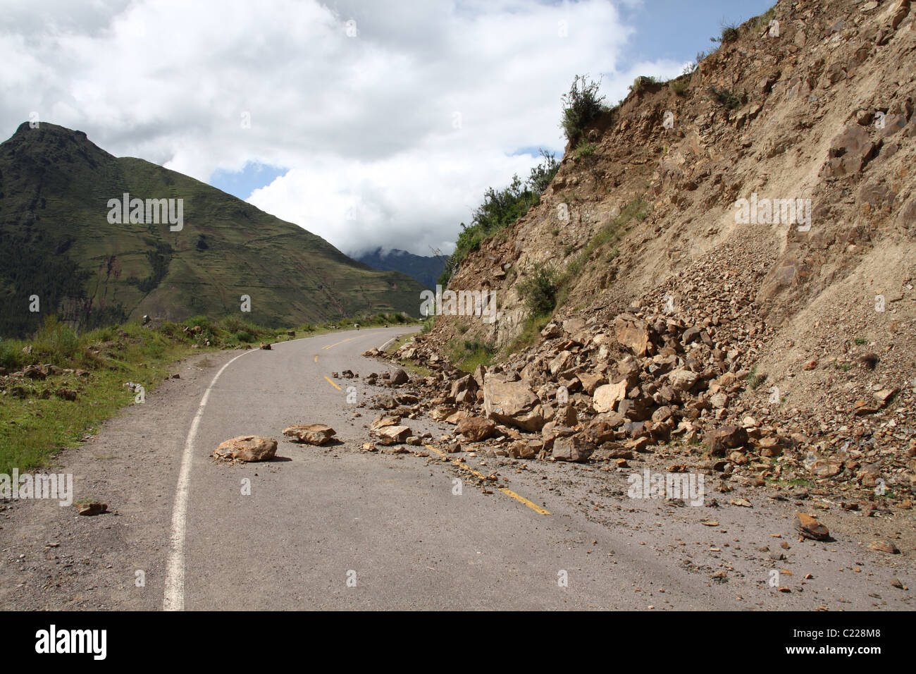 Dangerous rocks that fell on an asphalt road in Peru Stock Photo - Alamy