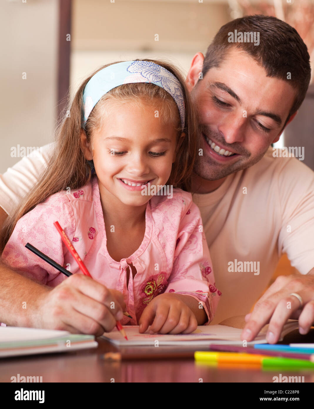 Concentrated smiling girl painting Stock Photo - Alamy