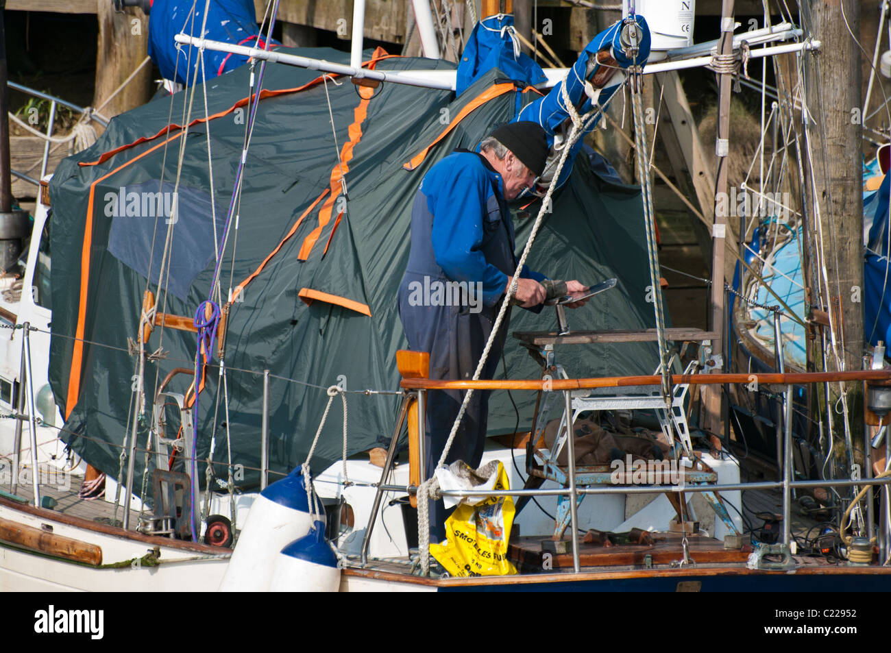 Man Carrying Out Boat Repairs Stock Photo - Alamy