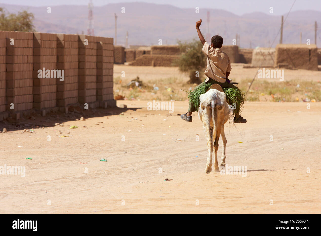 Sudanese boy riding donkey Stock Photo - Alamy