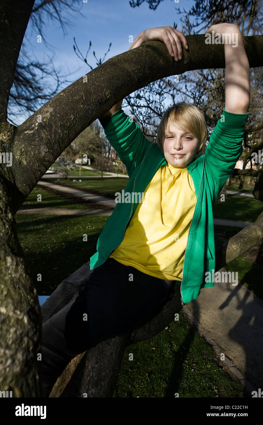 Teenager climbing a tree hi-res stock photography and images - Alamy