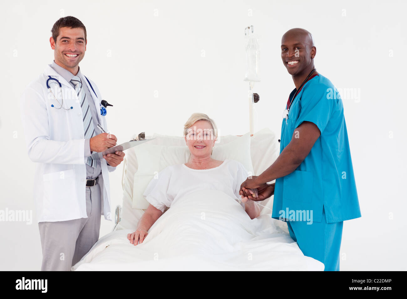 Team of doctors with a patient smiling at camera Stock Photo - Alamy