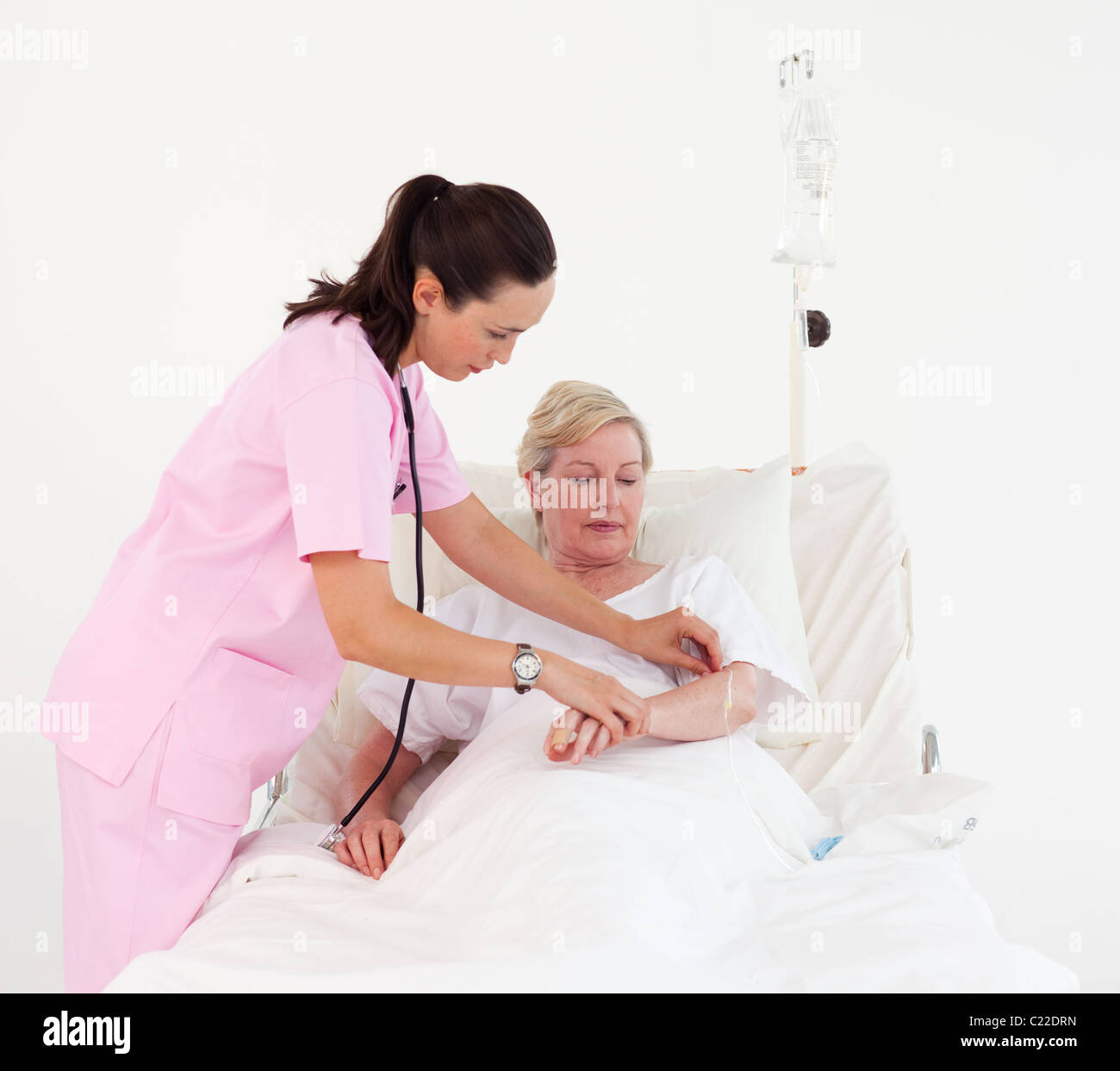 Caring nurse with a elderly woman Stock Photo - Alamy