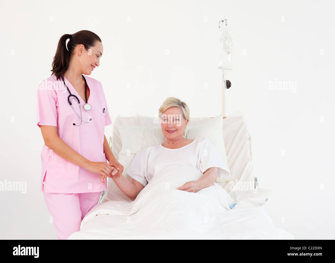 Young attractive nurse with an elderly nice patient Stock Photo - Alamy