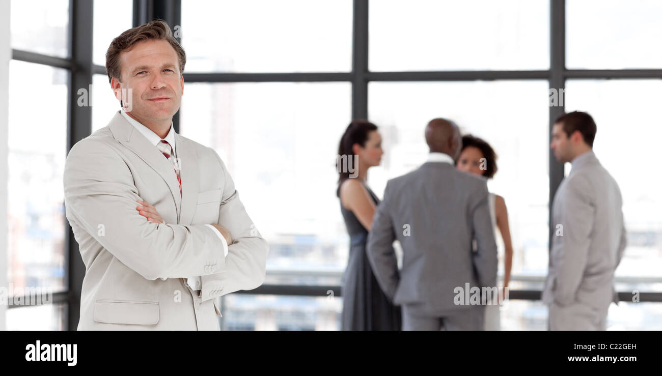 Attractive confident male manager leading his team Stock Photo - Alamy