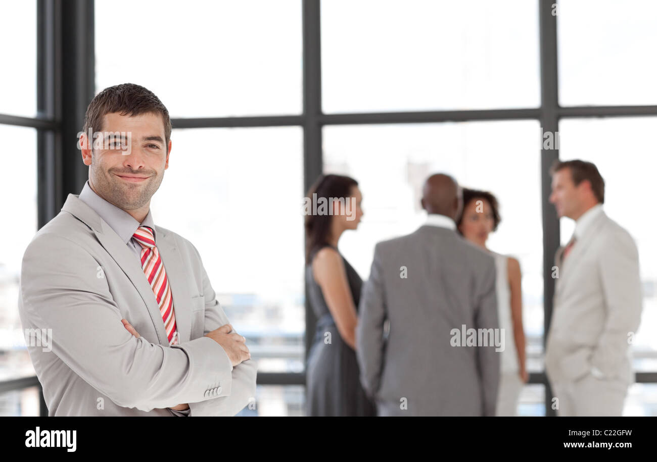 Handsome male manager leading his team Stock Photo - Alamy