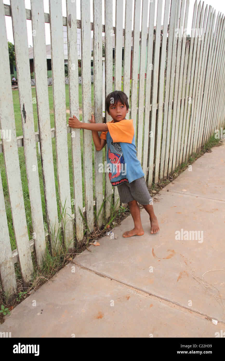 Young Latin American Boy standing beside fence Stock Photo - Alamy