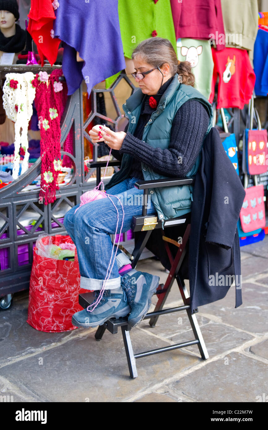 Covent Garden , bored attractive young brunette lady or woman stall ...
