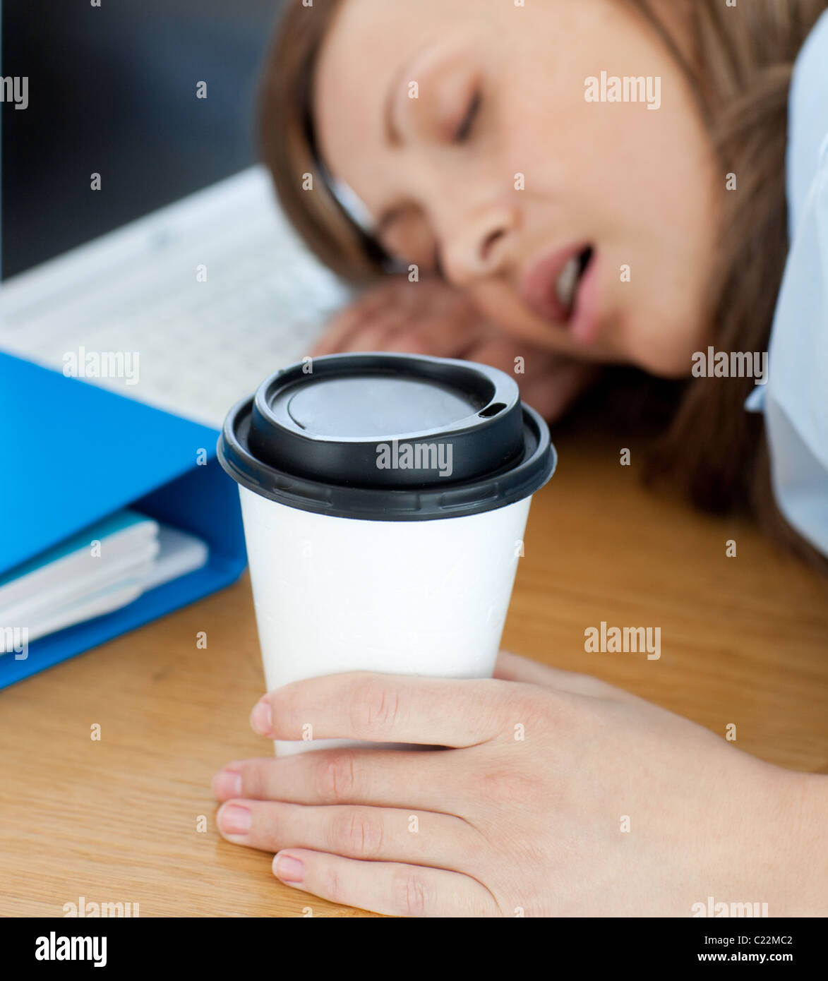 Languorous woman sleeping on table in office Stock Photo - Alamy